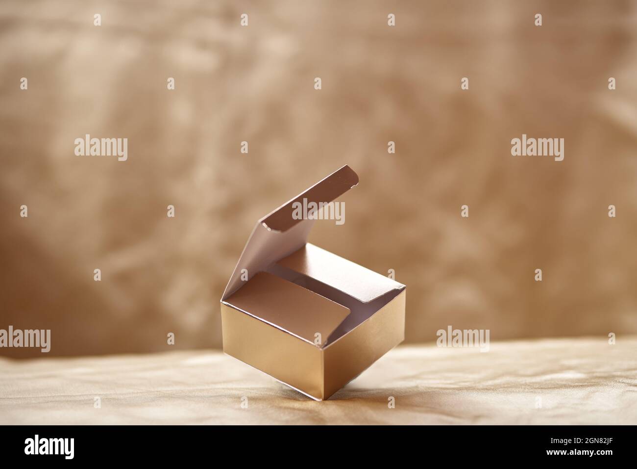 Golden premium carton box mock up on golden background. High quality ...