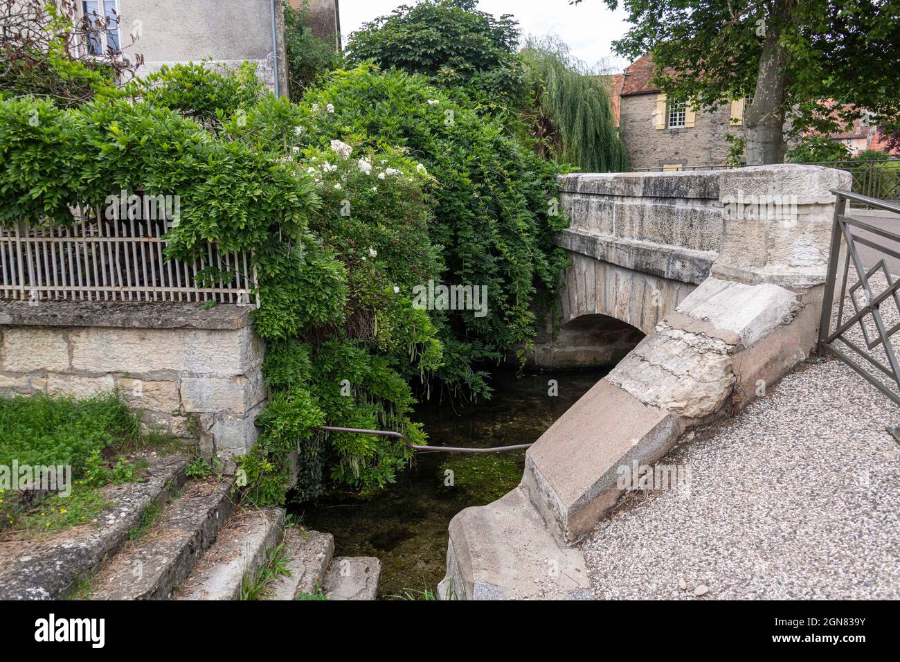 Steps lead down to the River Beze by the stone bridge, Cote d'Or ...