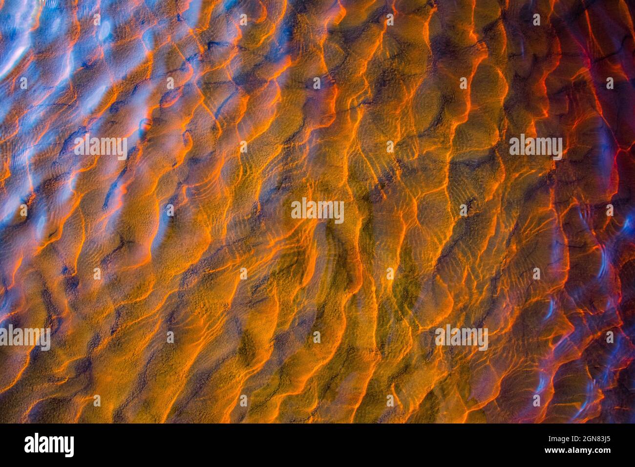 Clear golden water stream pattern with sand waves under it Stock Photo ...