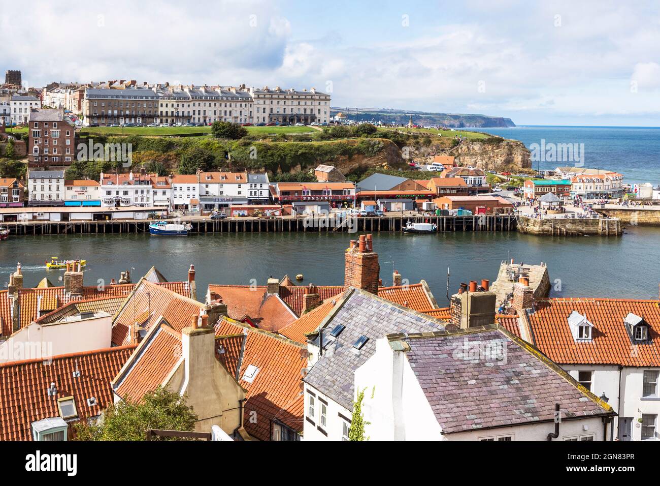 View of Whitby harbour showing fishing boats and private yachts in the ...