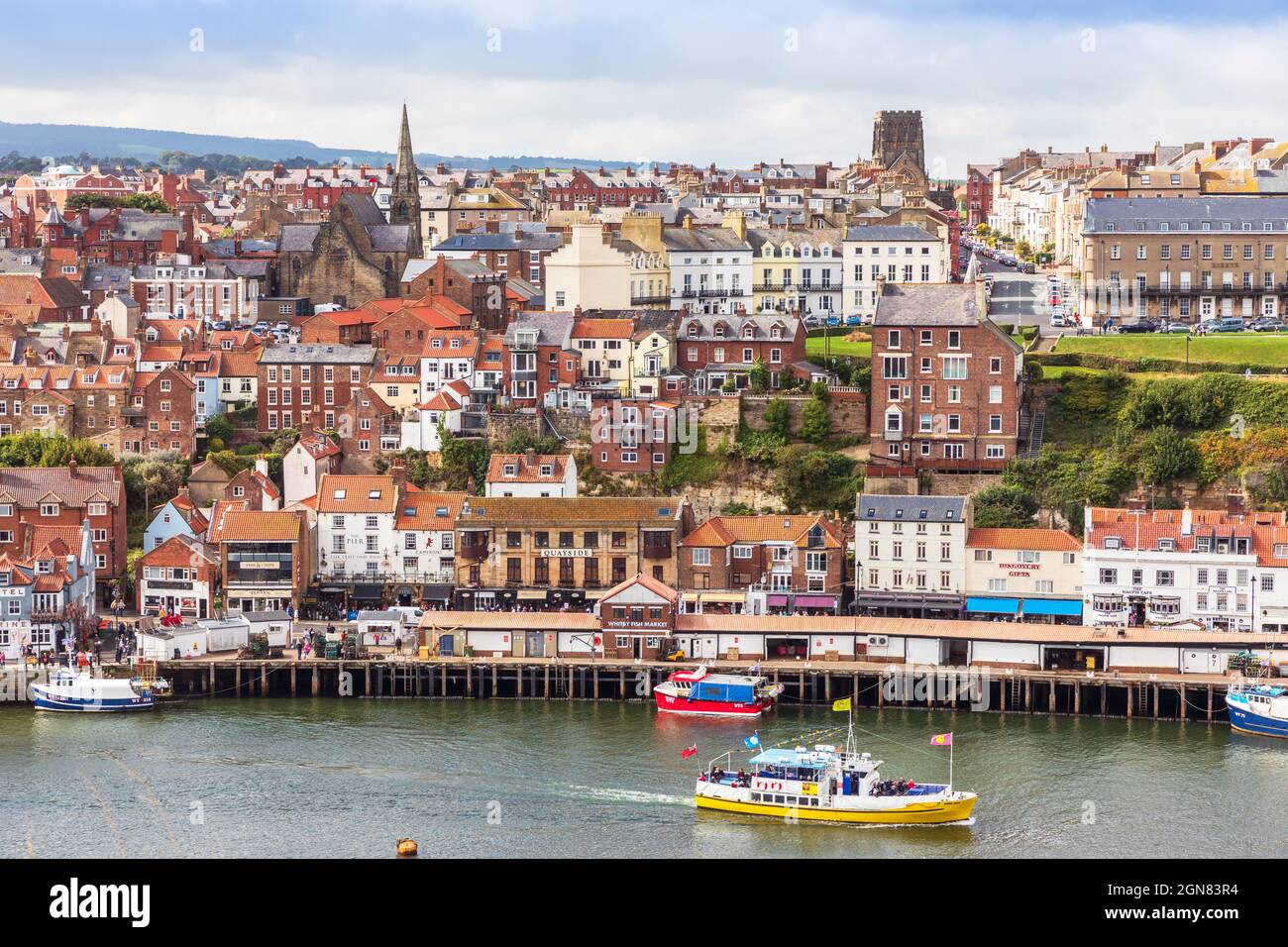 View of Whitby harbour showing fishing boats and private yachts in the ...