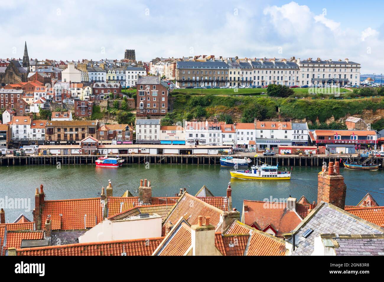 View of Whitby harbour showing fishing boats and private yachts in the ...