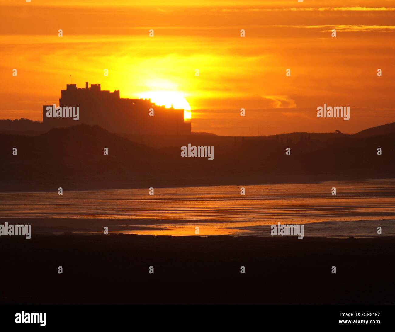 Bamburgh Castle from Seahouses Stock Photo - Alamy