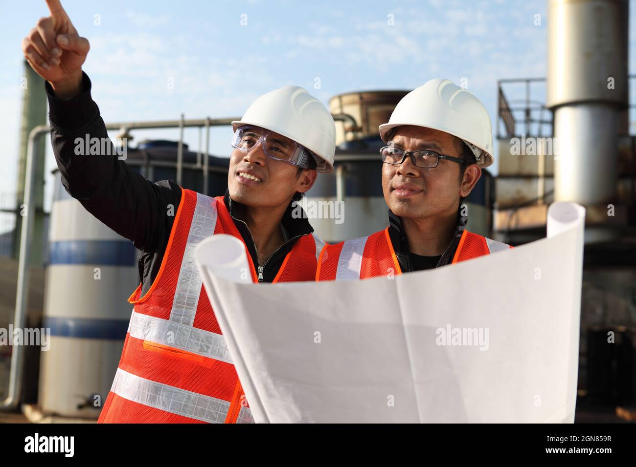 two engineer checking a drawing Stock Photo - Alamy