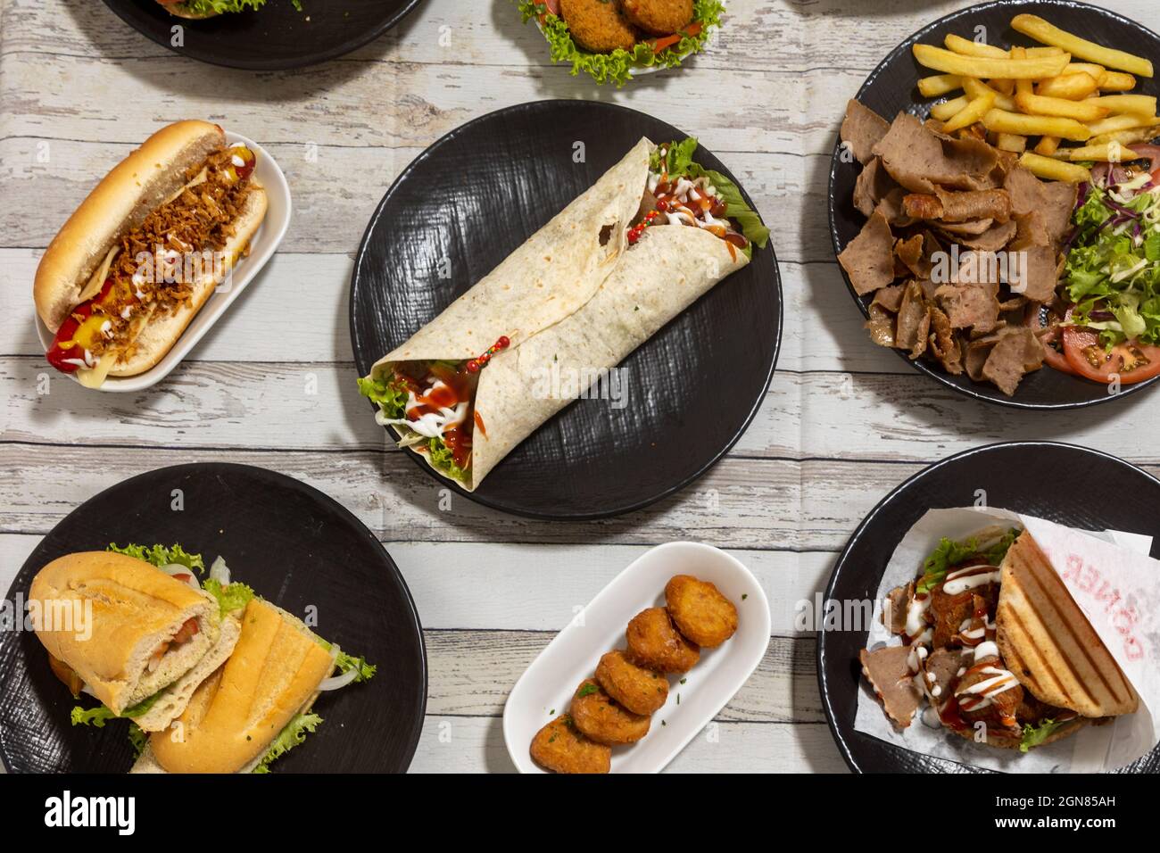 Closeup of various types of fast food on the table. Top view Stock ...