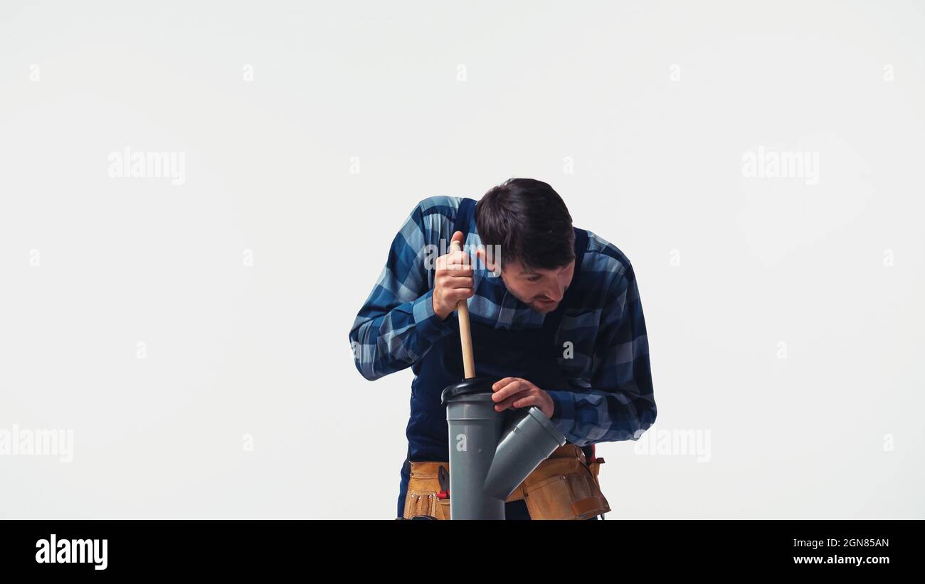 Plumber cleaning plastic pipe with plunger isolated on white Stock ...