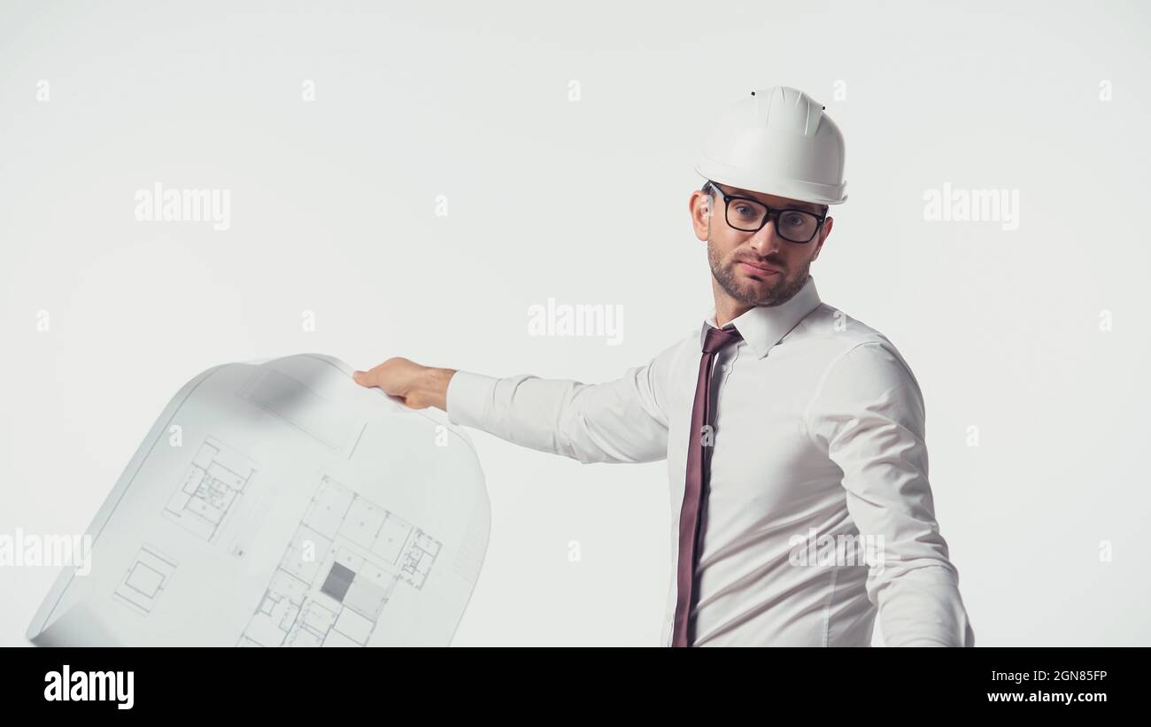 Engineer in hardhat holding blurred blueprint isolated on white Stock ...