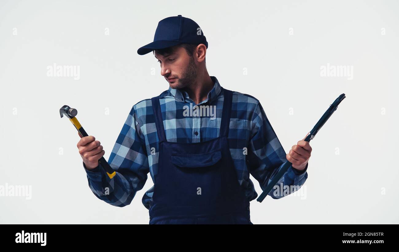 Handyman holding hammer and pipe wrench isolated on white Stock Photo ...