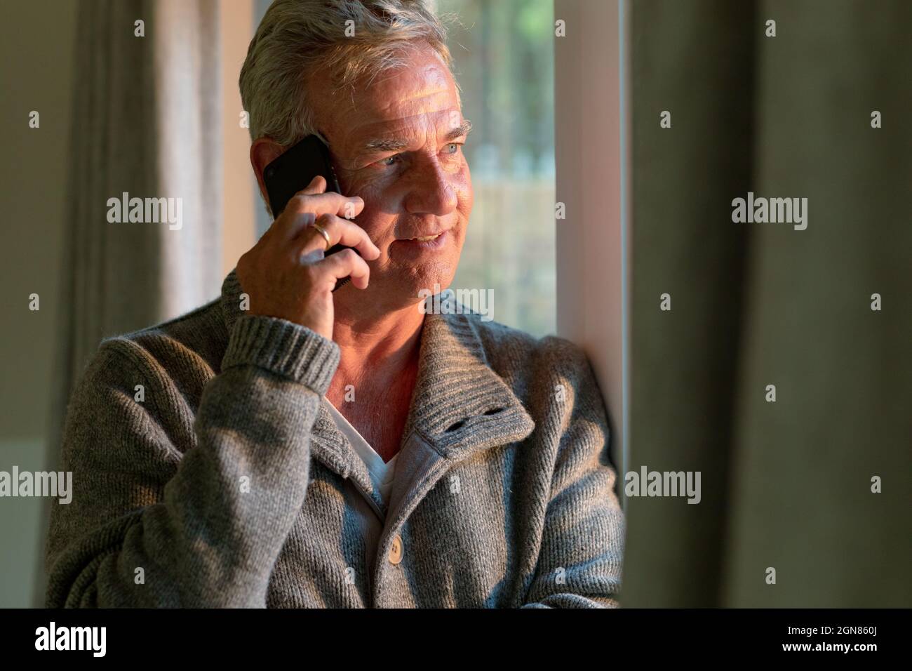 Man standing window hi-res stock photography and images - Alamy