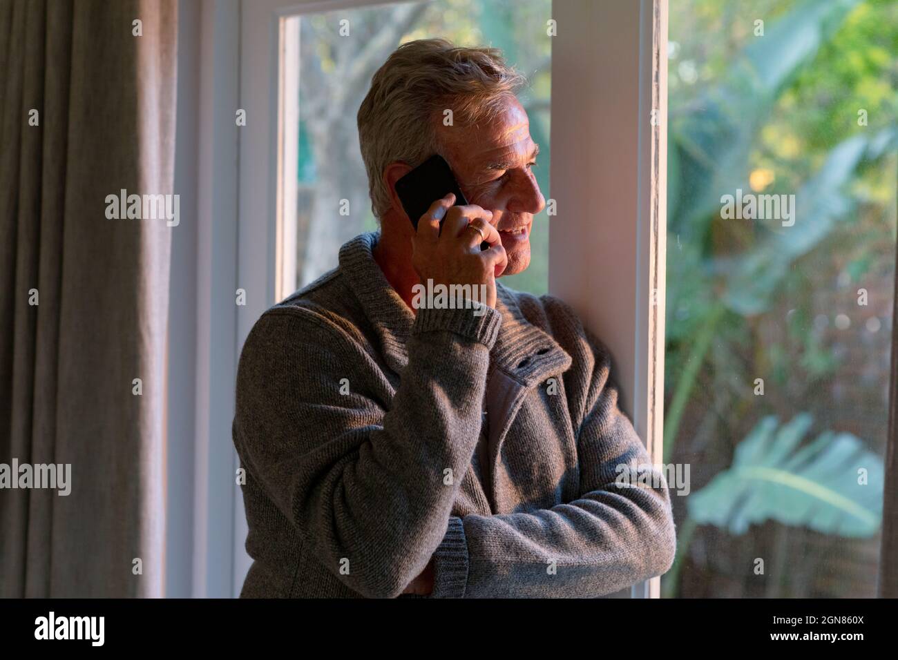 Man standing window hi-res stock photography and images - Alamy
