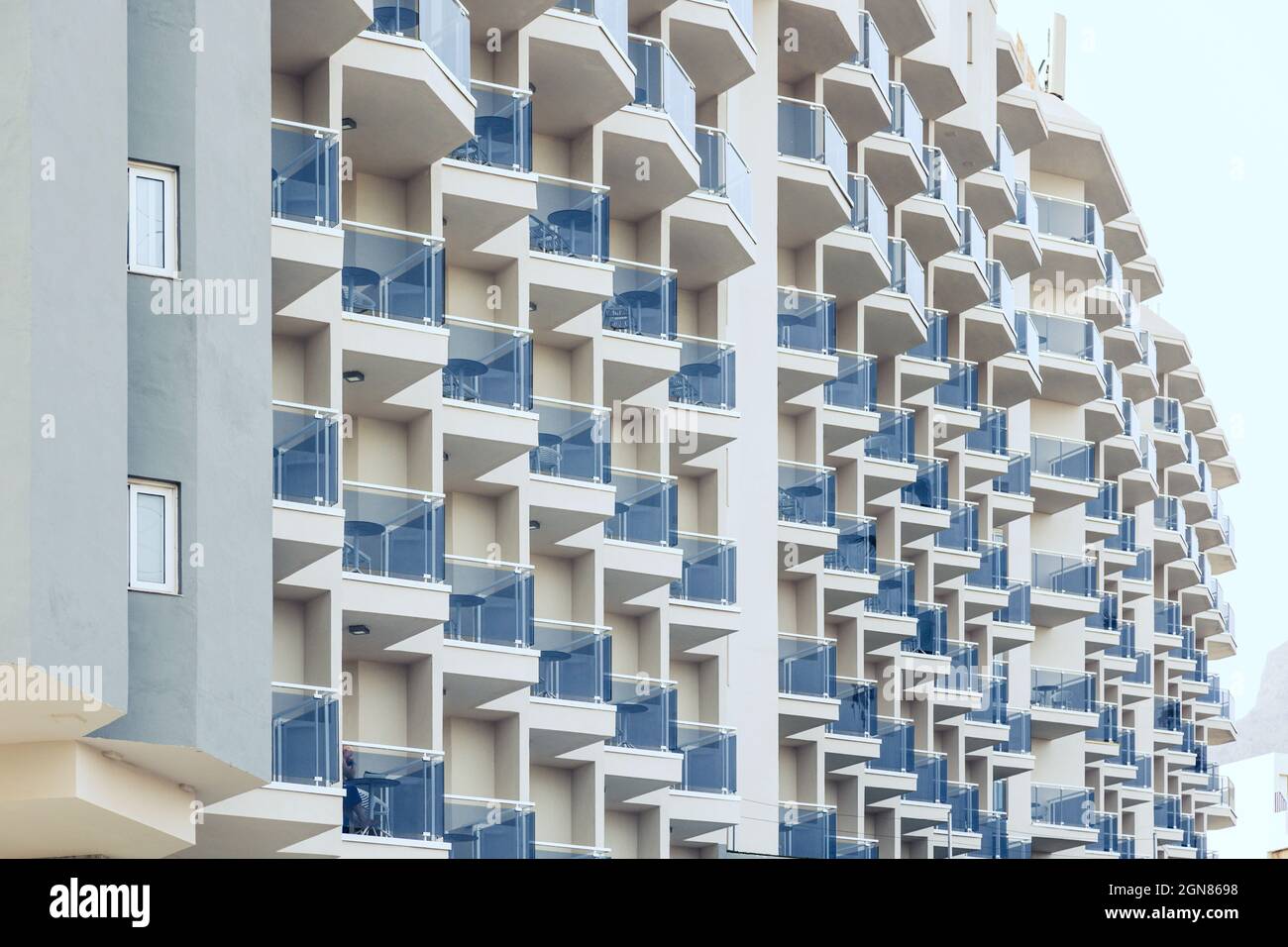 White building with blue balconies Stock Photo - Alamy