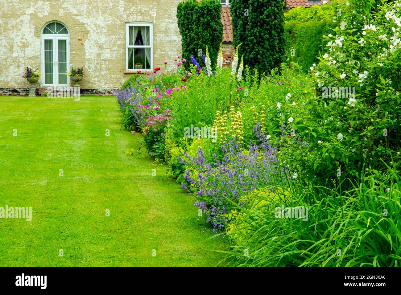 Flowers in borders in June at Goltho Gardens near Wragby in ...
