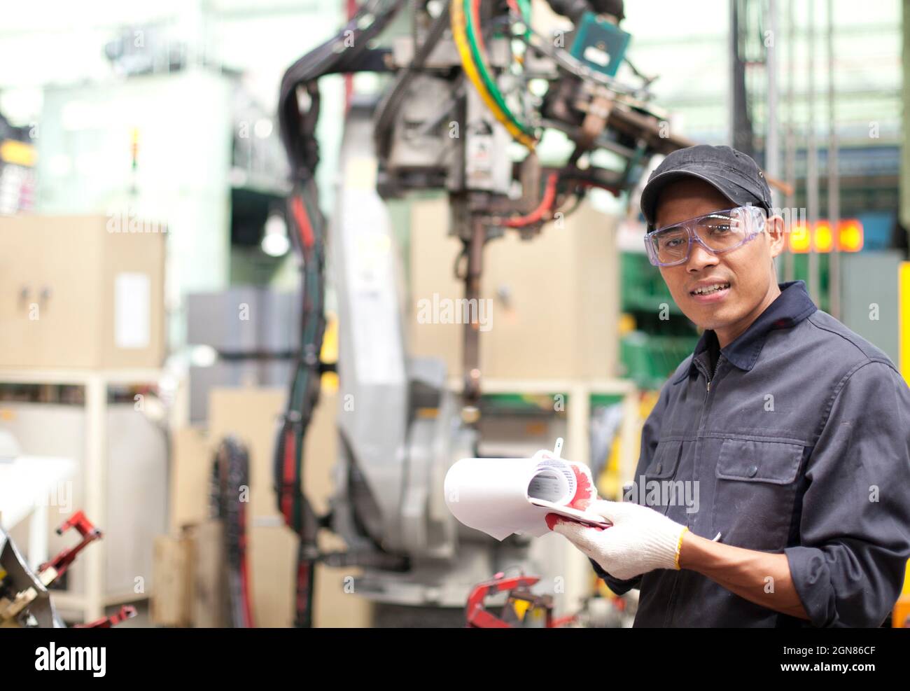 Workerman holding notepad in place work Stock Photo - Alamy