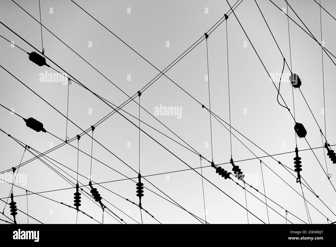 Tranquil grayscale shot of electrical network wires on a clear sky ...