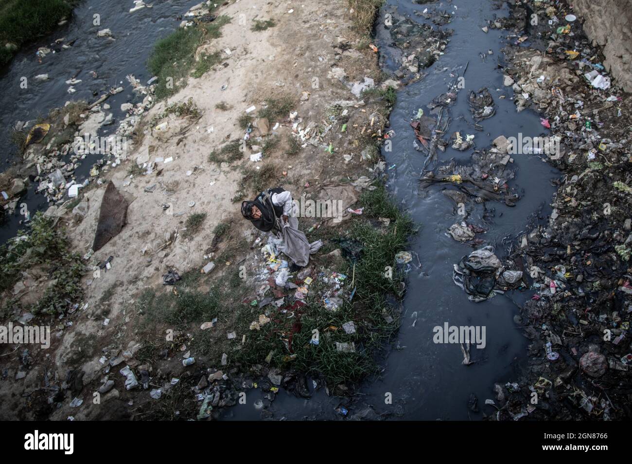 Kabul, Afghanistan. 23rd Sep, 2021. An Afghan man looks for plastic to ...