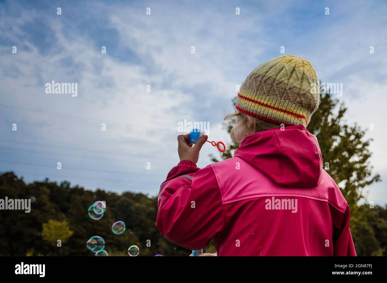 child having fun with soap bubbles outdoors Stock Photo - Alamy