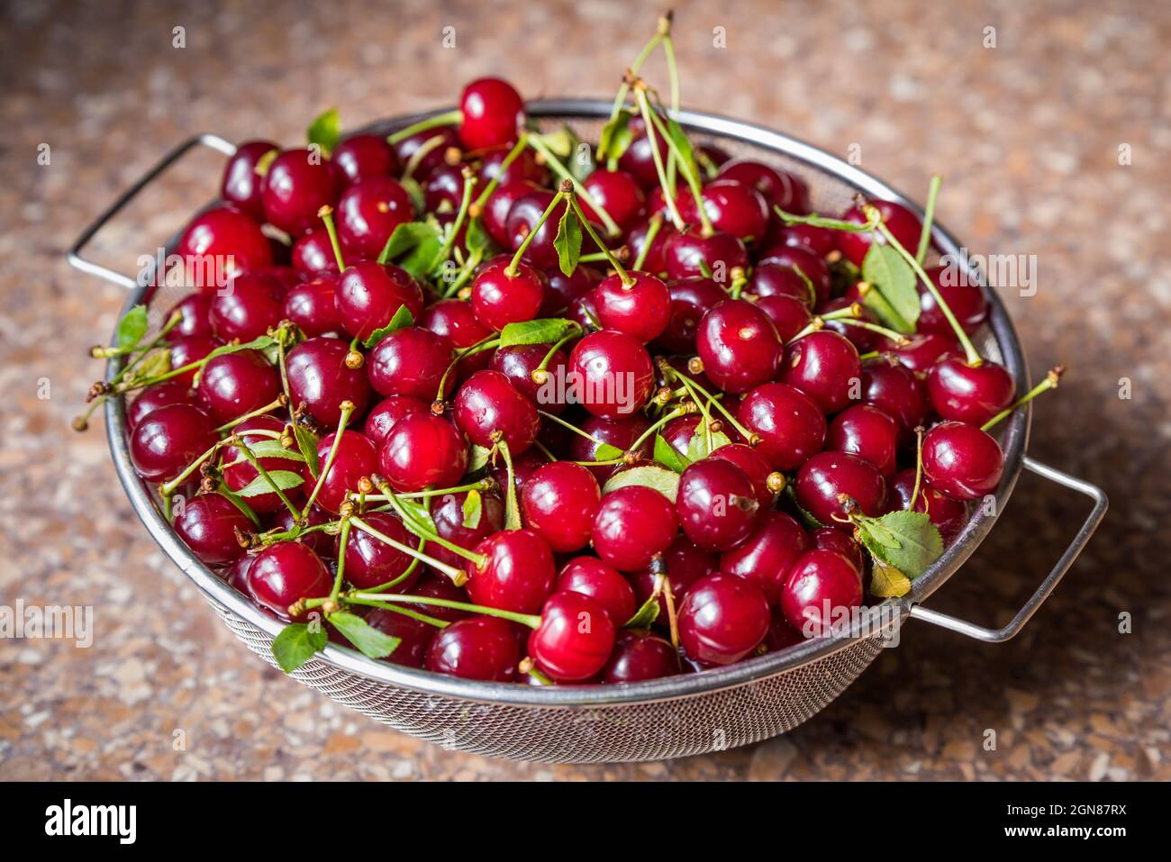 Cherries in a steel sieve. top view, texture Stock Photo - Alamy