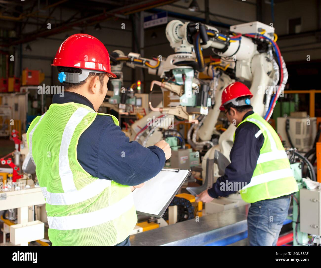 Two workers plant checking hi-res stock photography and images - Alamy