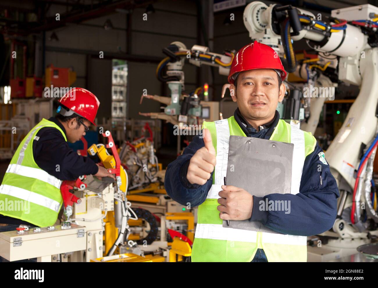 Asian foreman thumb up hi-res stock photography and images - Alamy