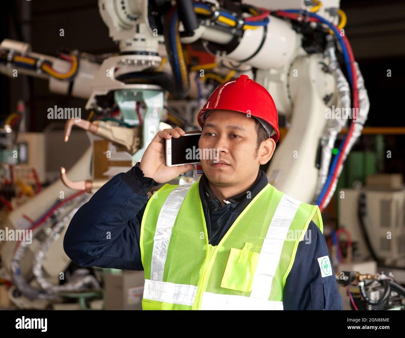 Factory worker communication via phone Stock Photo - Alamy