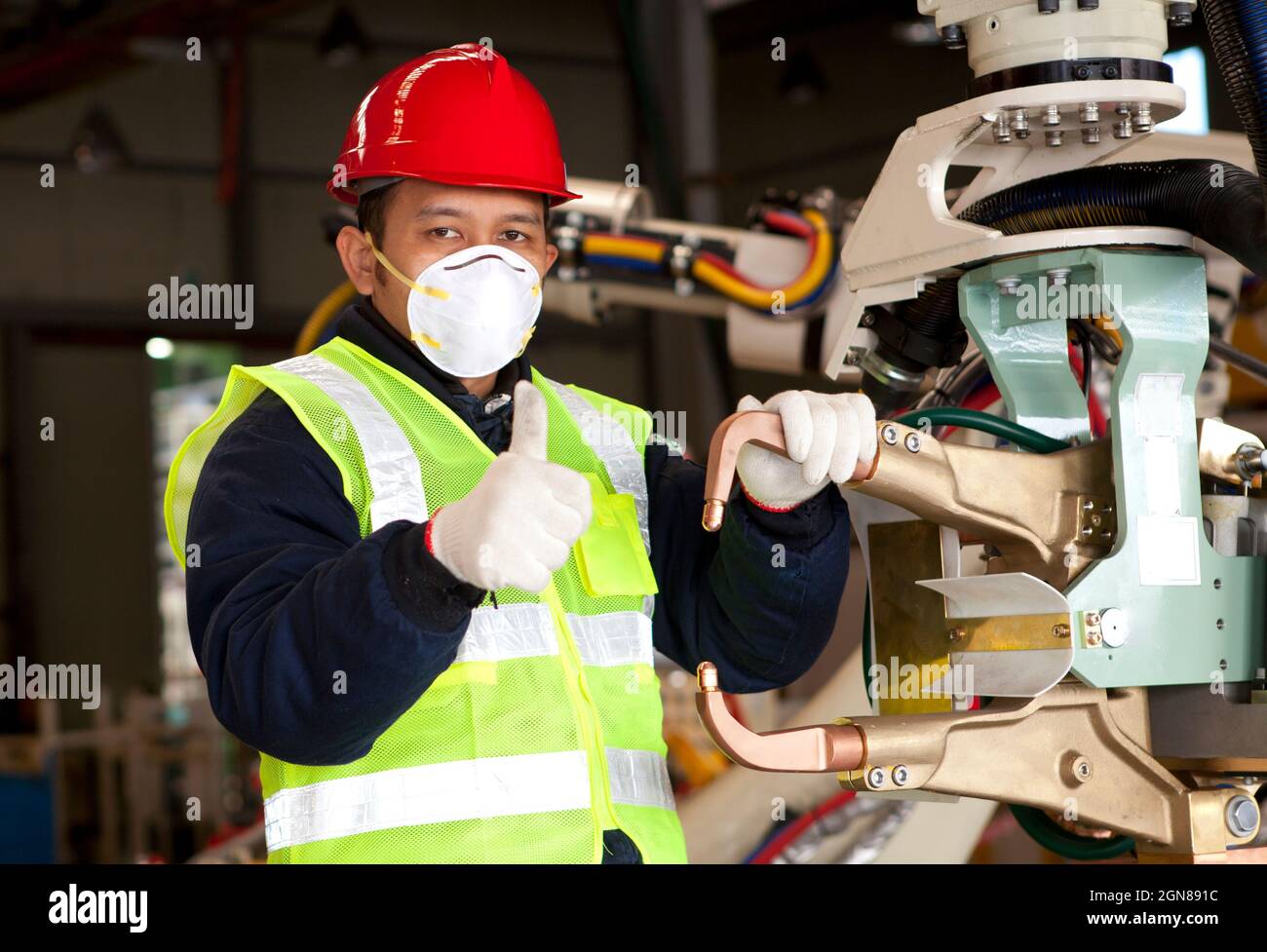 Factory worker with robot machine Stock Photo - Alamy