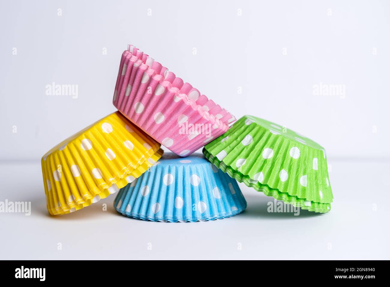 four packs of brightly colored grease proof paper cup( fairy) cake ...