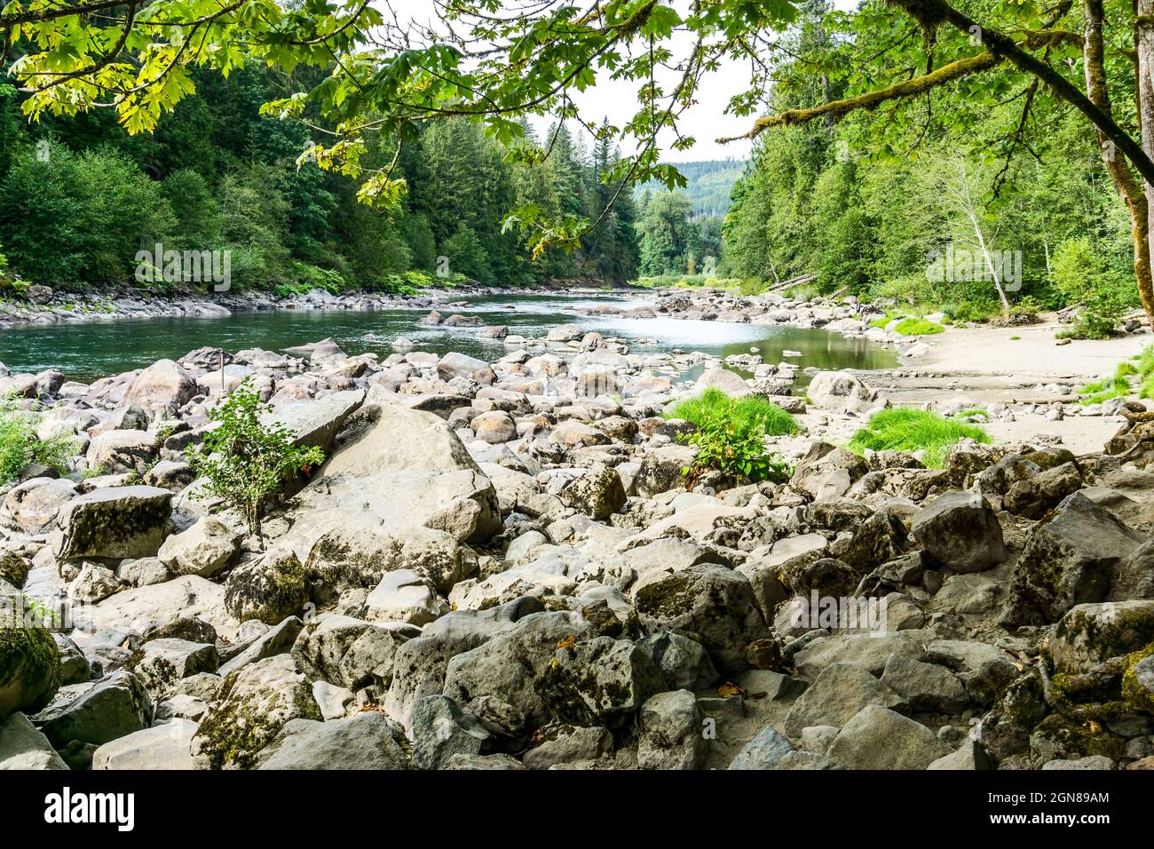 Rocks line the shore along the Snoqualmie River in Washington State ...