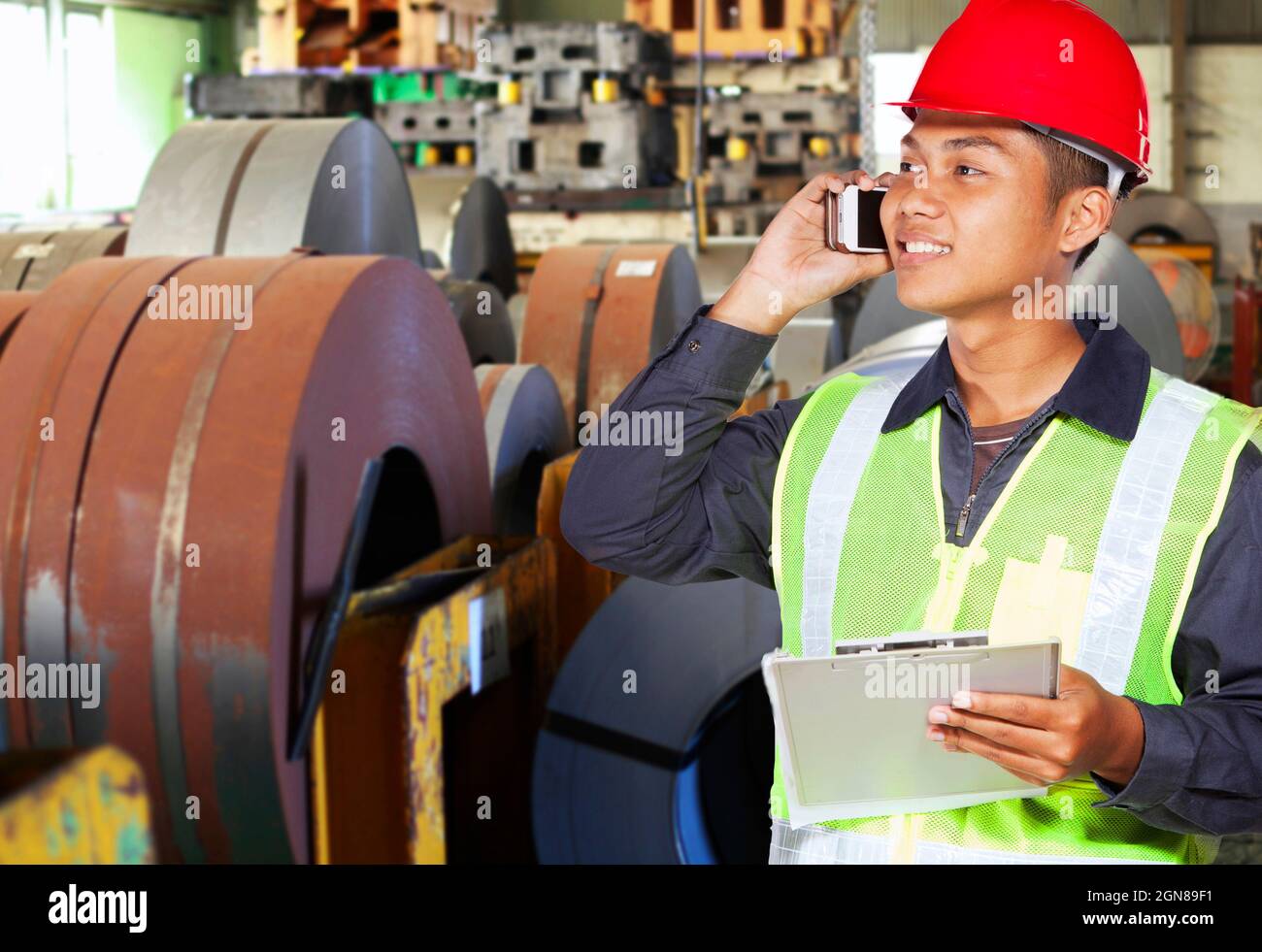 Industrial engineer communication via phone in factory Stock Photo - Alamy