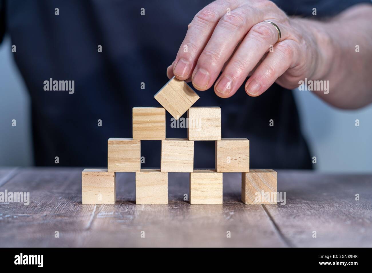 template mock up of ten timber block cubes with a man holding the top ...