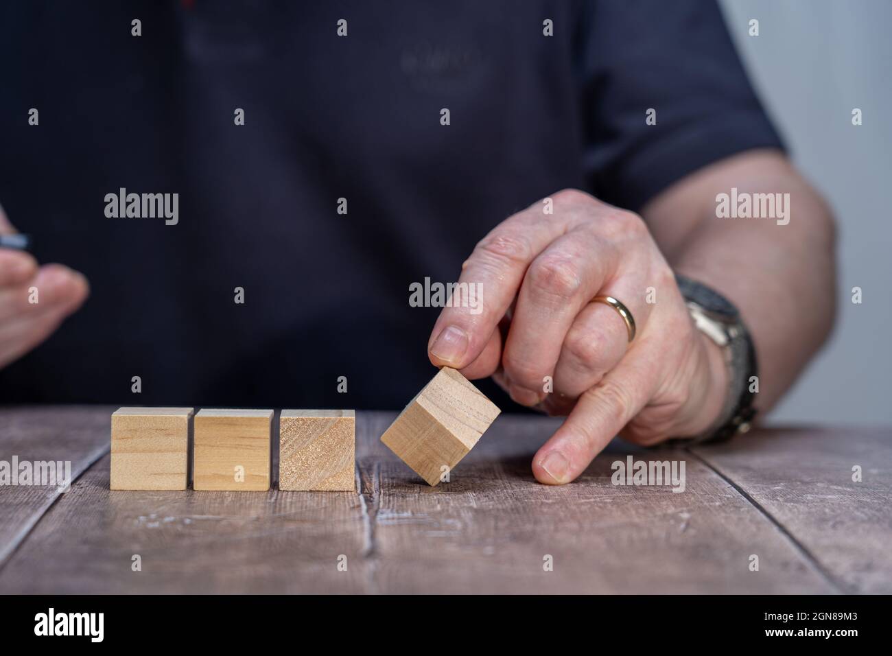 A mock up of Four blank timber block cubes three in a block with a man ...