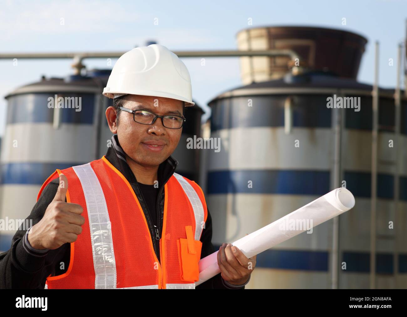 Industrial engineer giving thumbs up with blueprint on the hand Stock ...