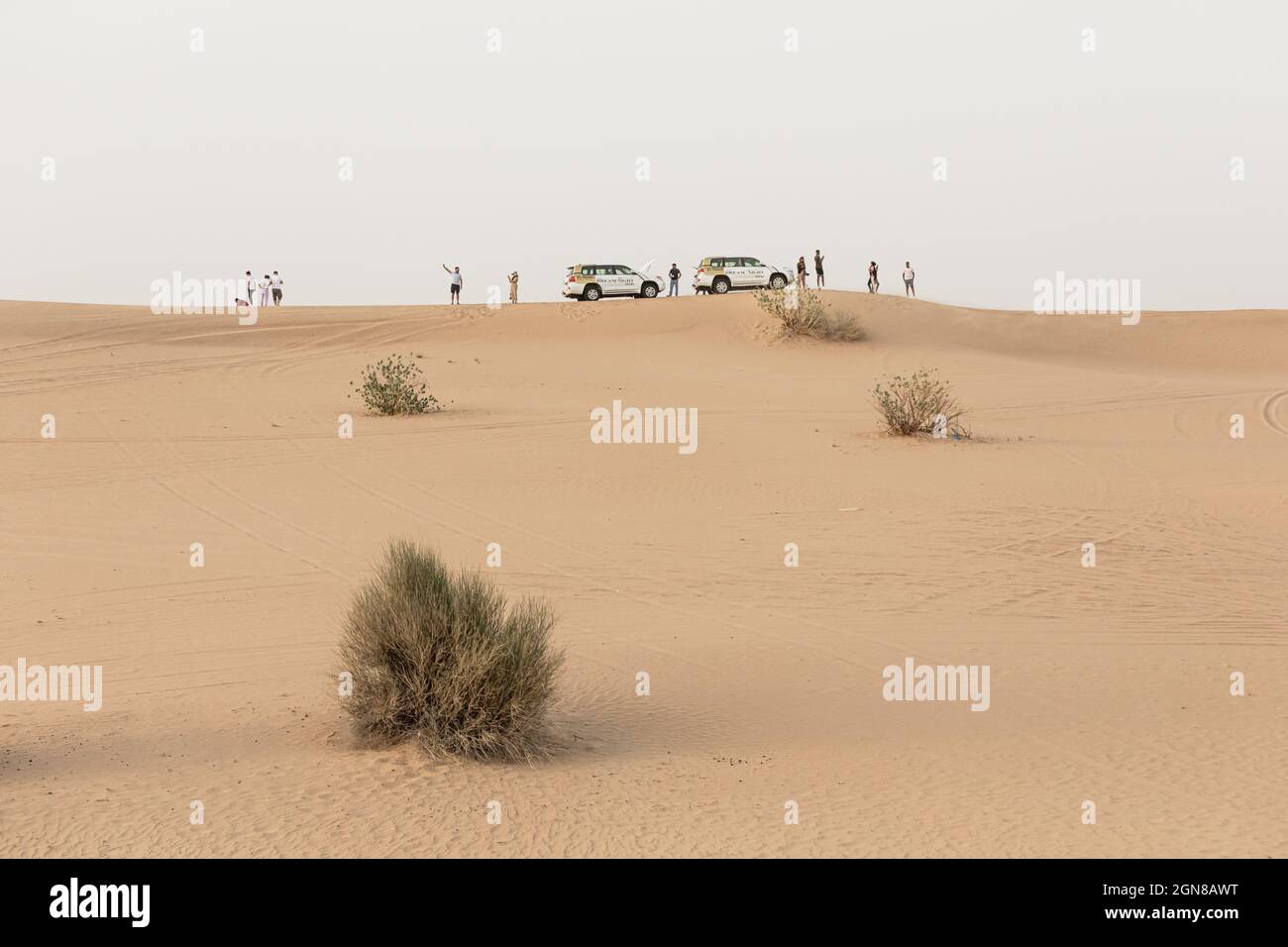 DUBAI, UAE - SEPTEMBER 4, 2018: People stand on the dune during desert ...