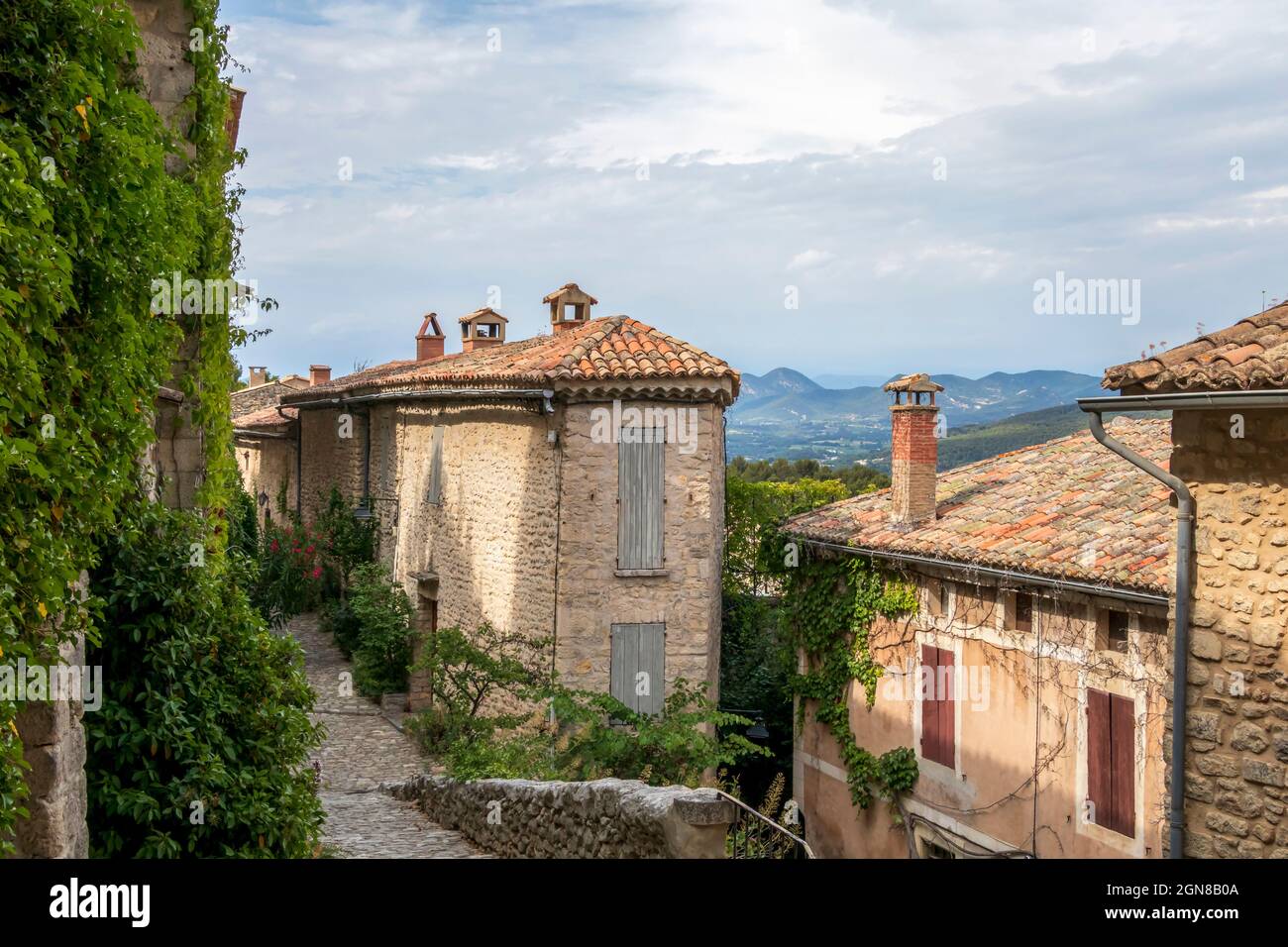 Crestet narrow street of typical provencal old town, medieval village ...