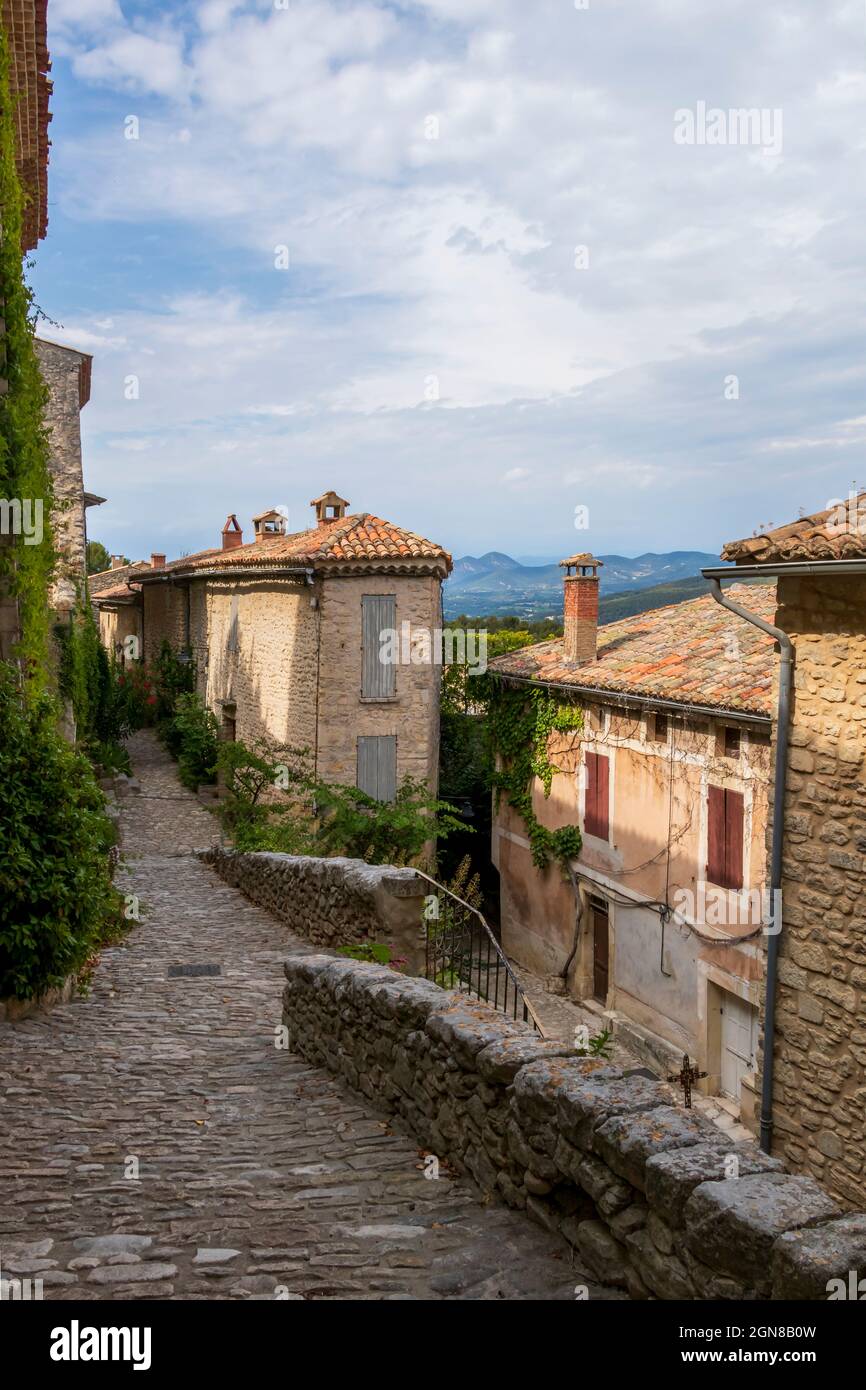 Crestet narrow street of typical provencal old town, medieval village ...
