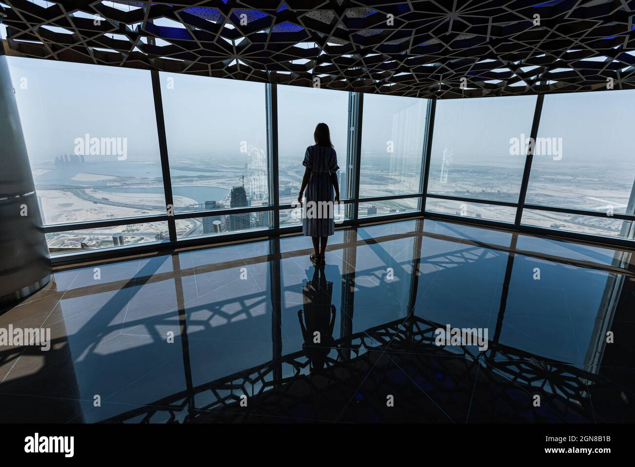 A young woman at the observation deck of Burj Khalifa, Dubai, UAE Stock Photo - Alamy