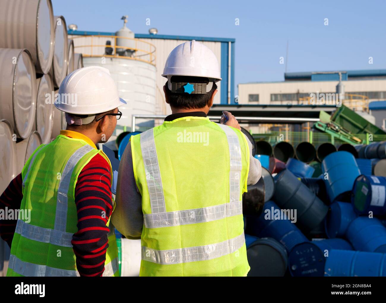 Manufacture workers checking drums Stock Photo - Alamy