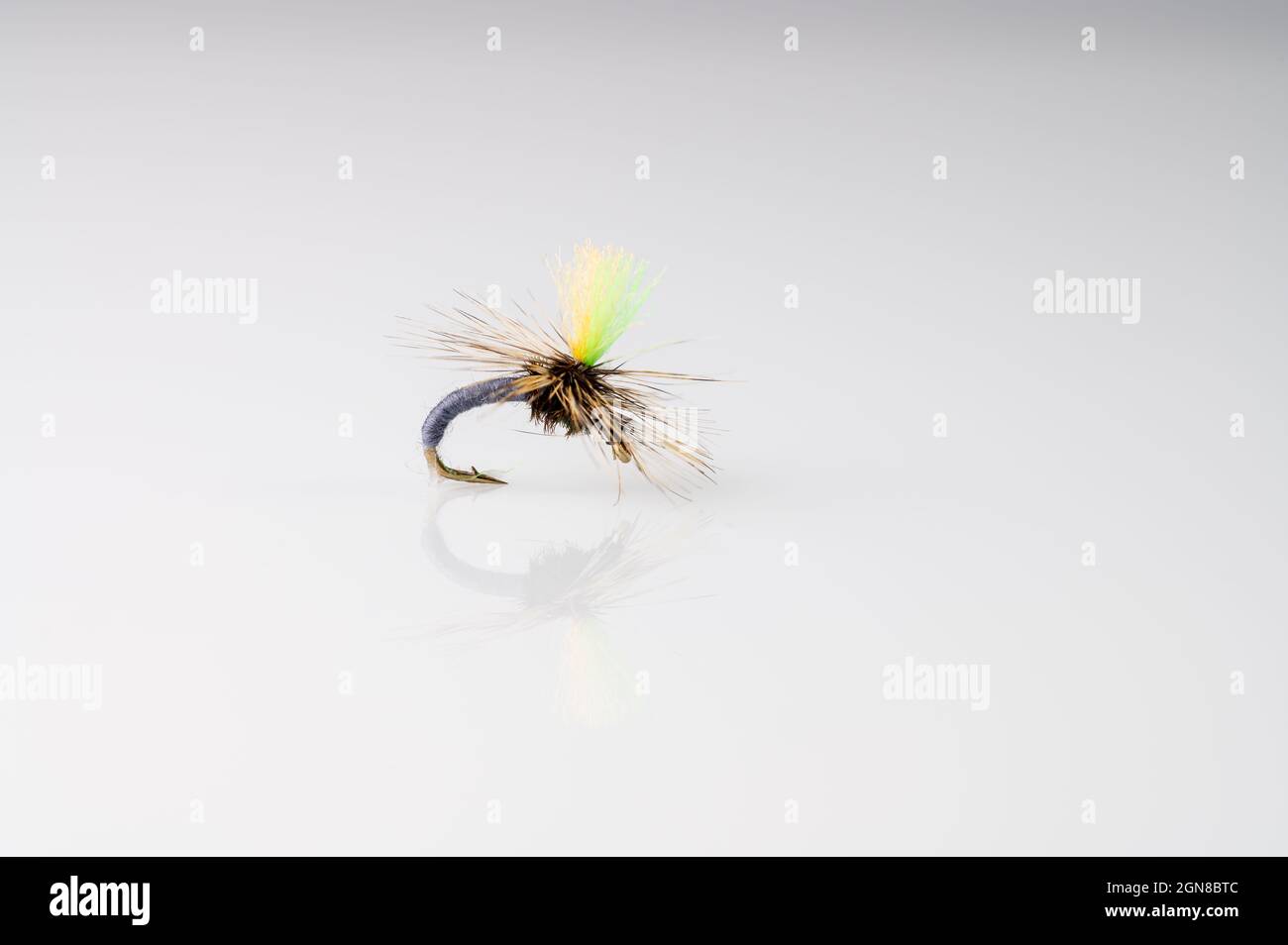 Traditional grey klinkhammer Dry Fly Fishing fly against a white ...
