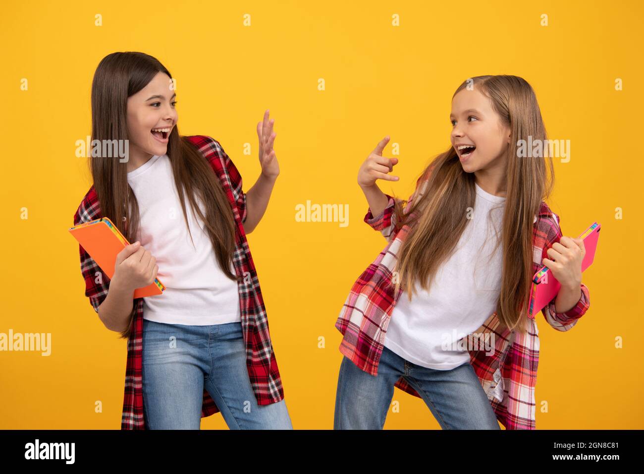 glad happy children in casual checkered shirt with copybooks, fun Stock ...