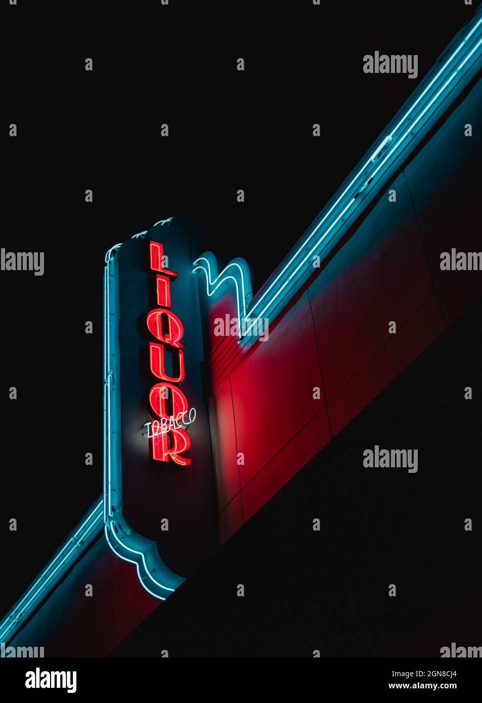 Red "Liquor" glowing red sign on a building with blue neon lights Stock ...