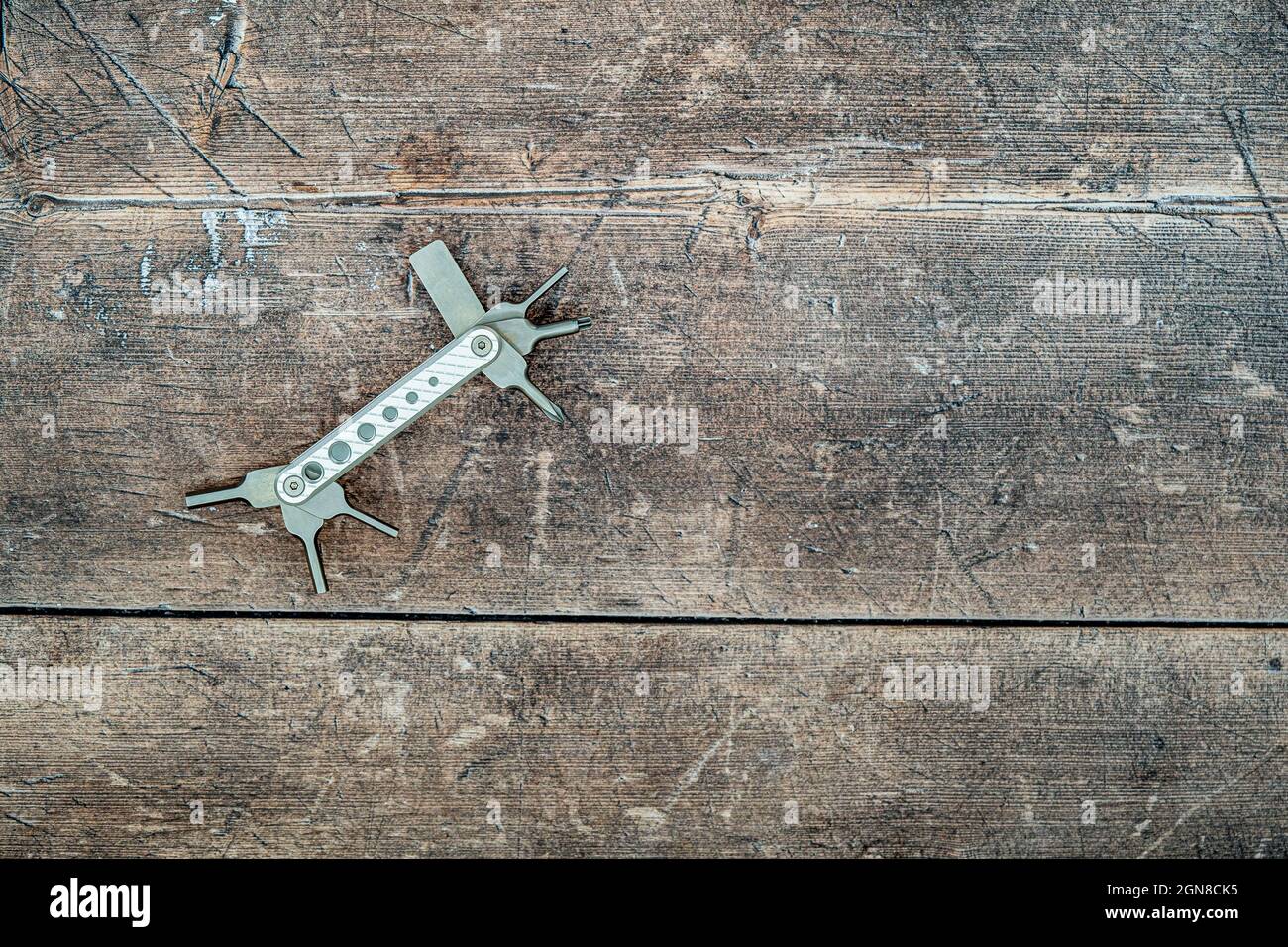 New Stainless steel Multi tool Screwdriver set on a plain wood ...