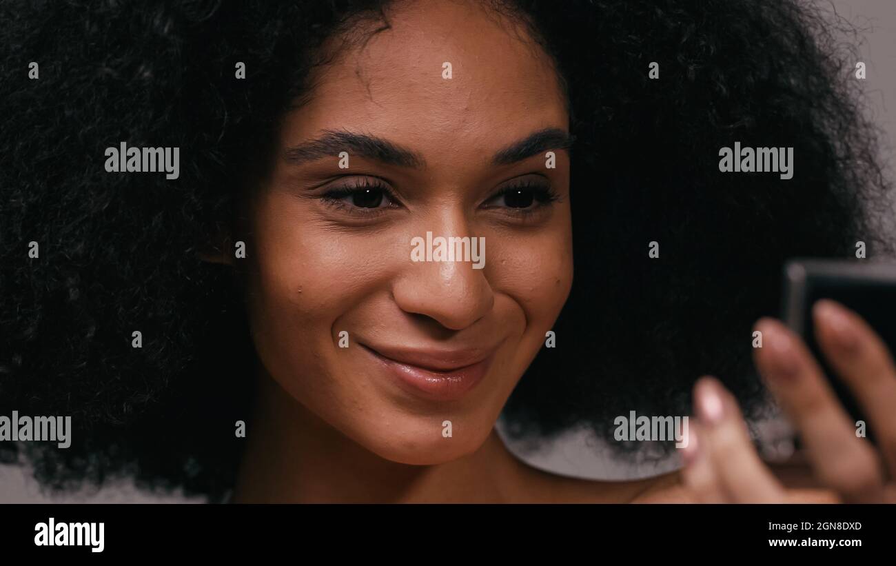 happy brunette african american woman looking at blurred mirror Stock ...