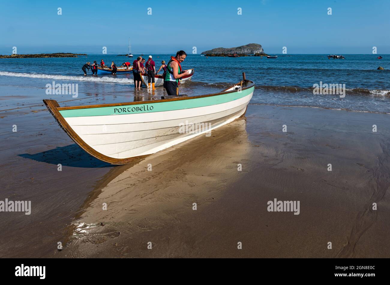 Portobello coastal rowing club team launch boat at regatta, North ...