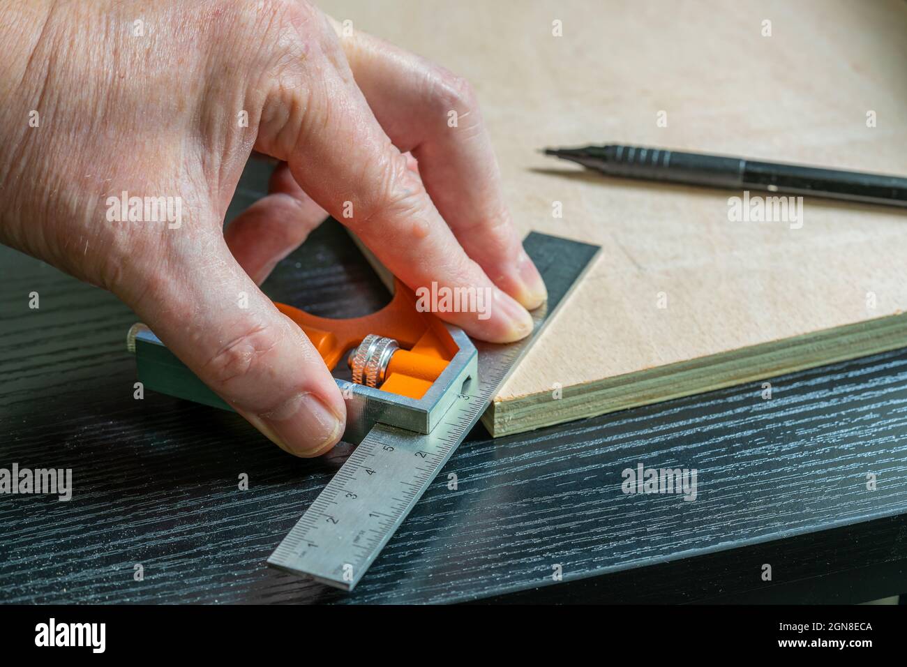 selected focus of a caprpenter marking out a perfect forty five degree ...