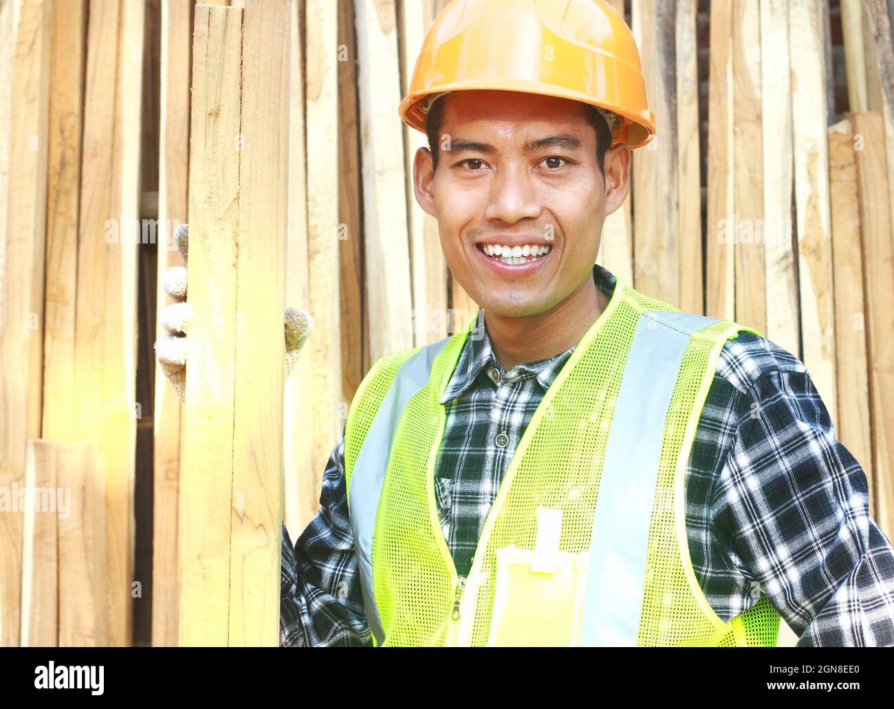 Portrait of a smiling carpenter holding wood look on your camera Stock ...