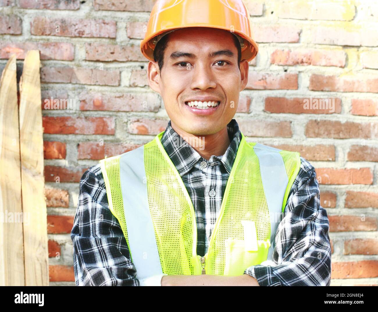 Portrait of man construction worker standing front of wall construction ...