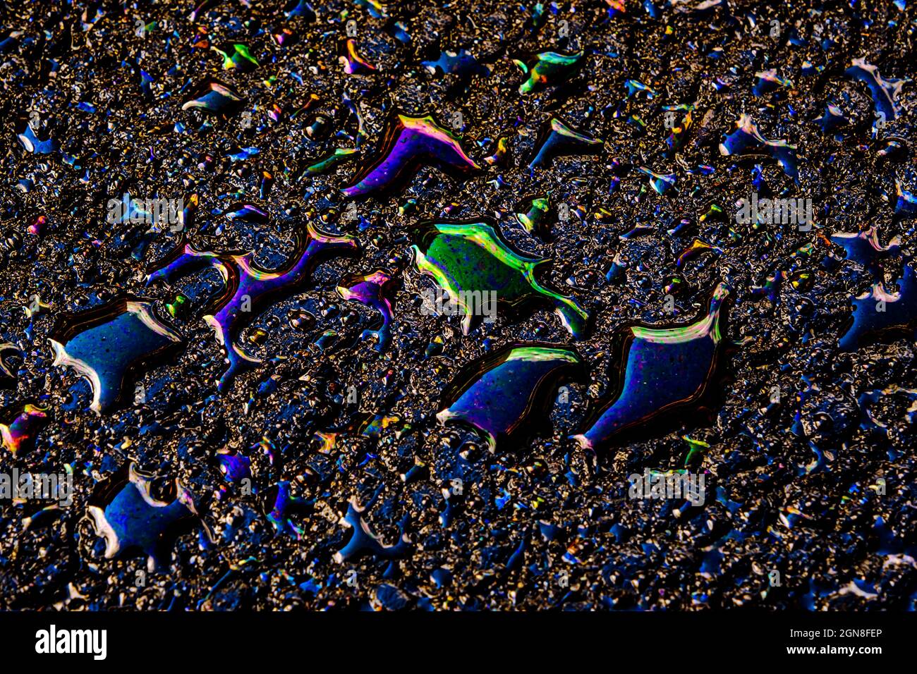 Oil stain on Asphalt road after rain, color Gasoline fuel spots on ...