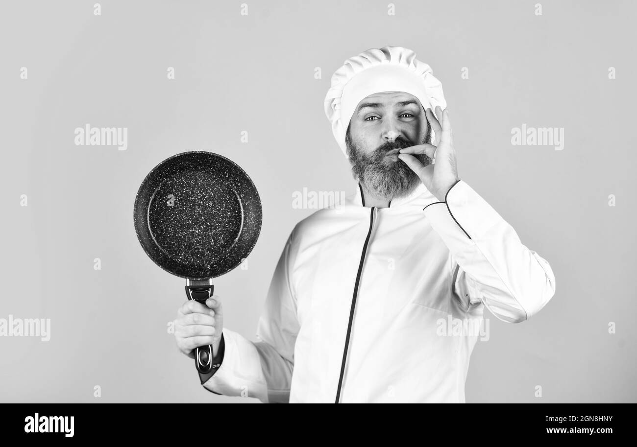 Healthy food. Bearded chef preparing breakfast. Frying without oil ...