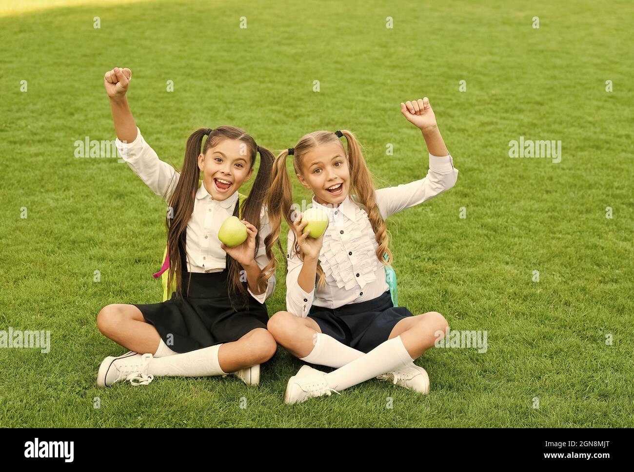 School students girls eating apples for lunch, child care concept Stock ...