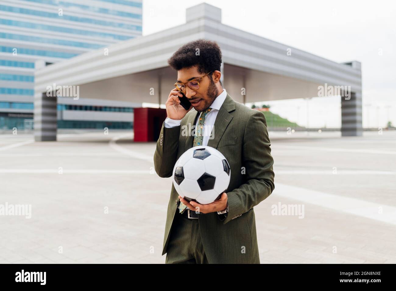 African businessman holding soccer ball hi-res stock photography and ...