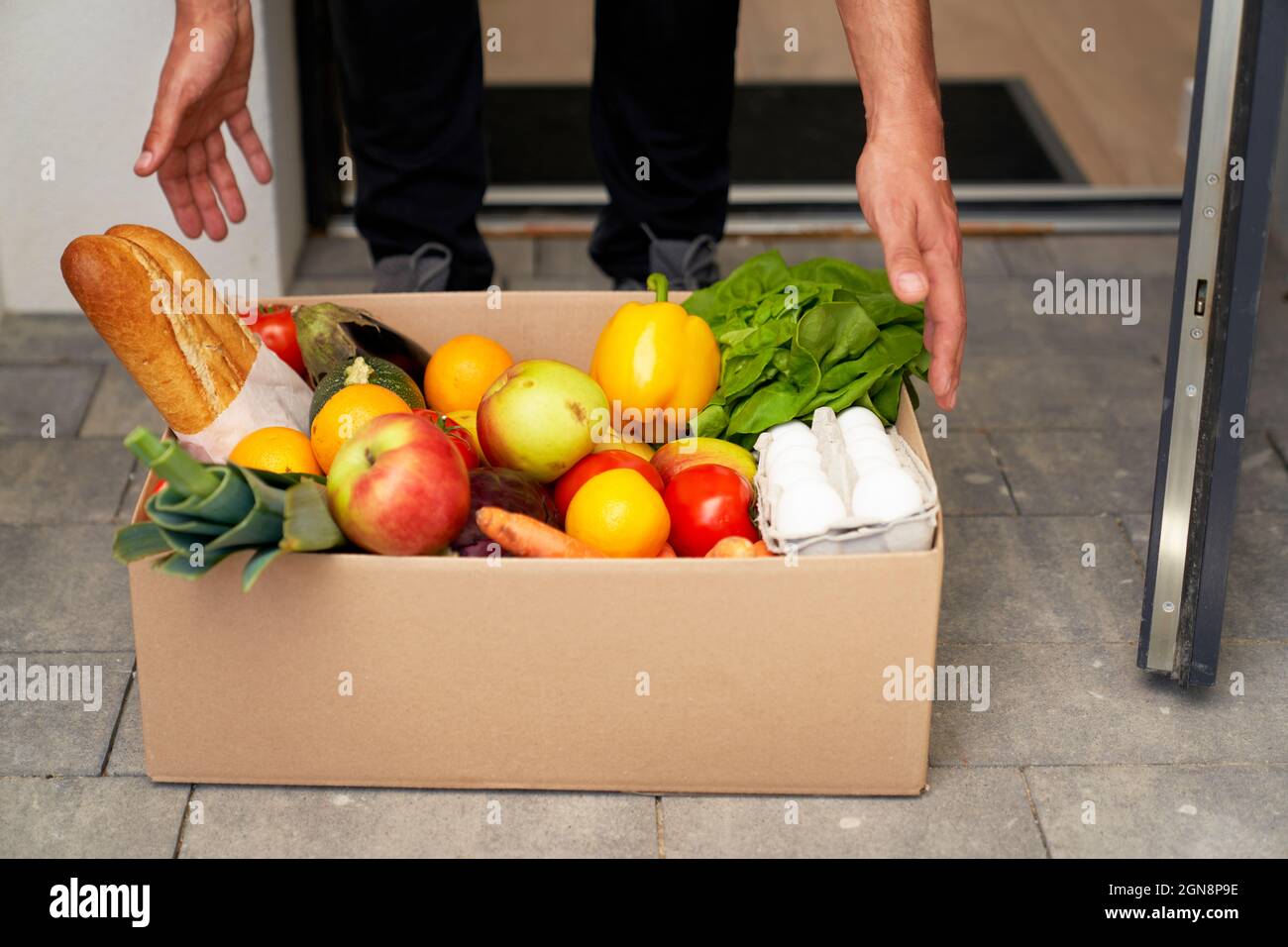 Man receiving groceries order at doorstep Stock Photo - Alamy